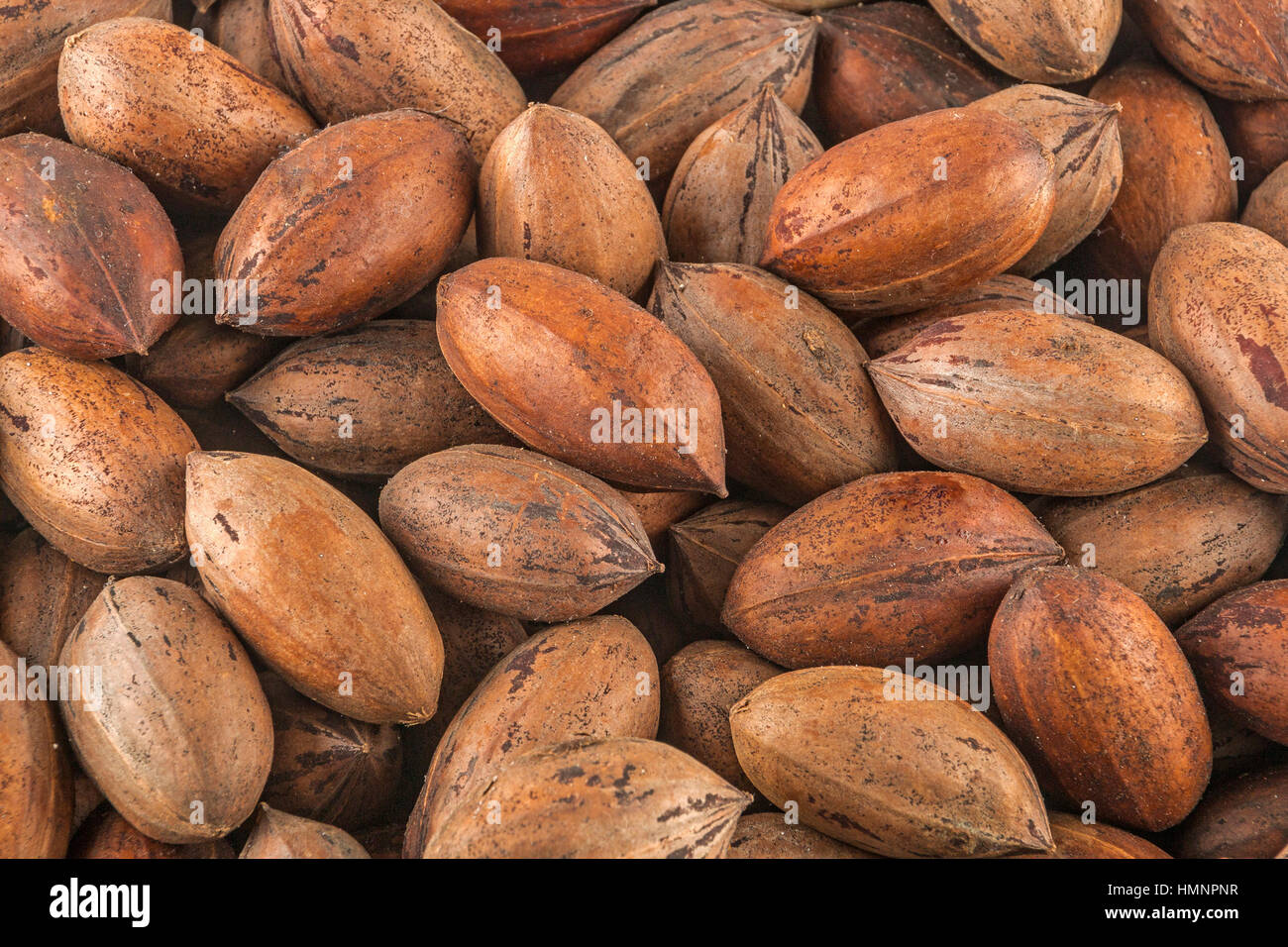 Close up above view of natural stack of peacan nuts patterns and ...