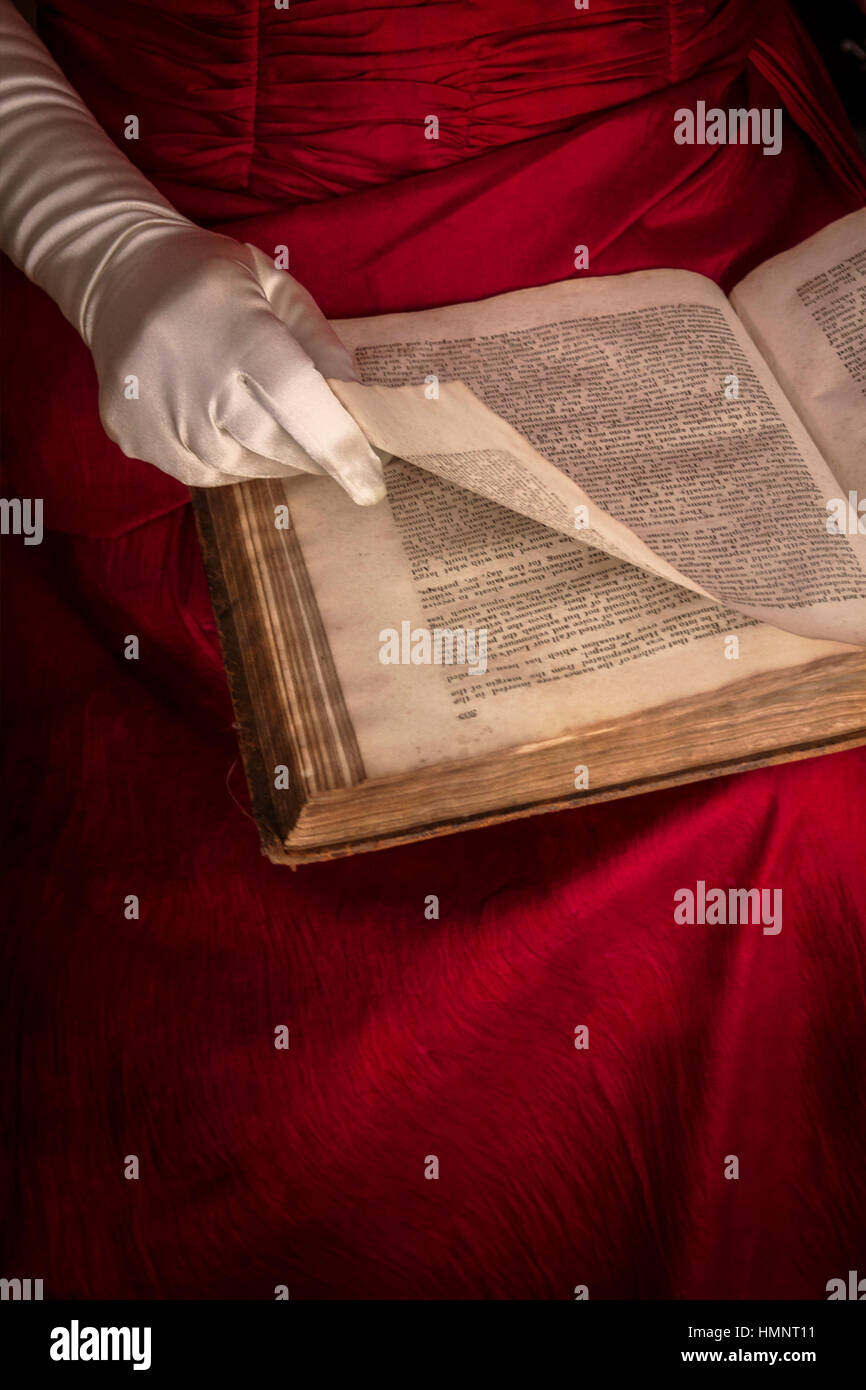 Female in Red dress reading book Stock Photo - Alamy