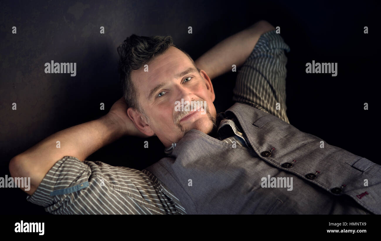 Handsome man in 50s lying hi-res stock photography and images - Alamy