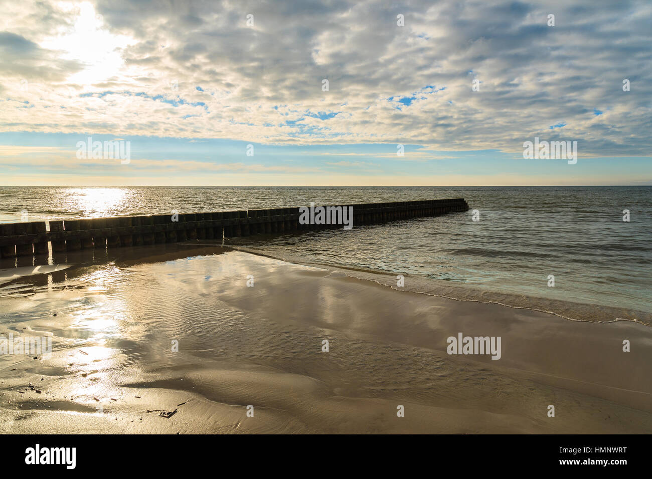 View of Leba beach during sunny day with clouds just before sunset ...