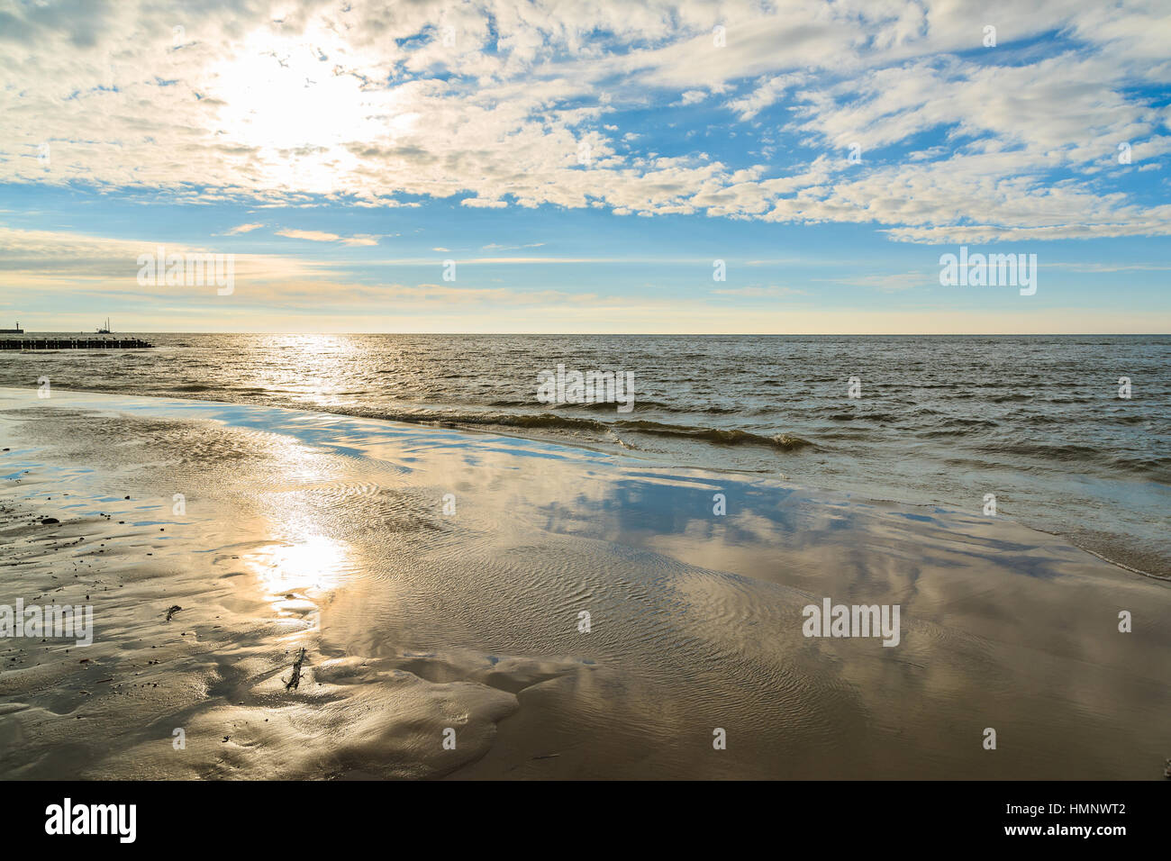 View of Leba beach during sunny day with clouds just before sunset ...