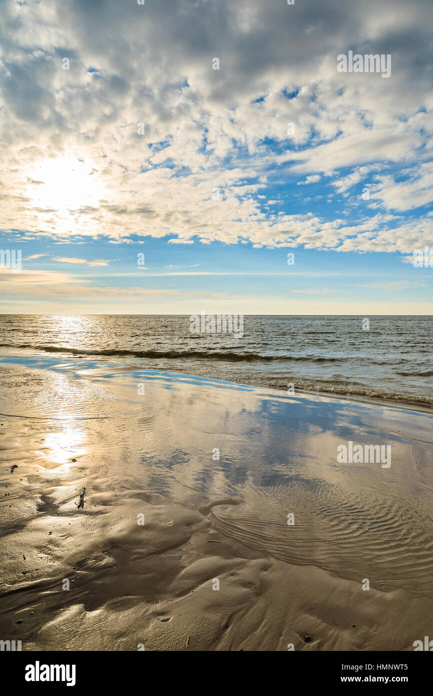 View of Leba beach during sunny day with clouds just before sunset ...