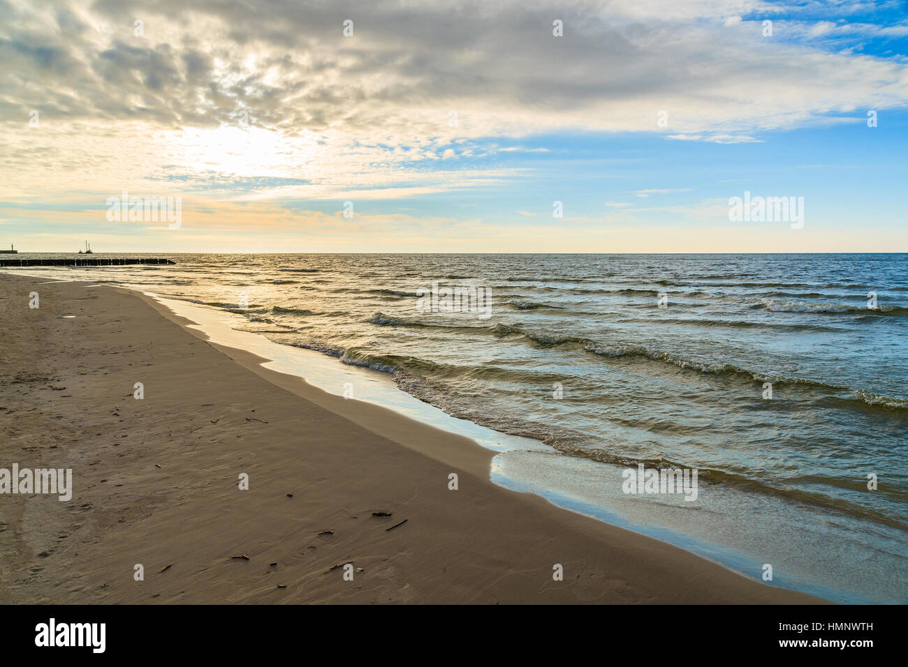 View of Leba beach during sunny day with clouds just before sunset ...