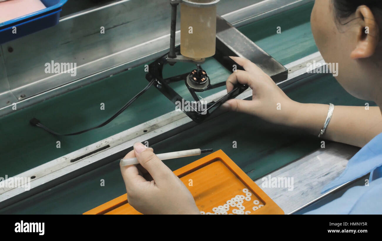 Worker in a factory of computer fans Stock Photo - Alamy