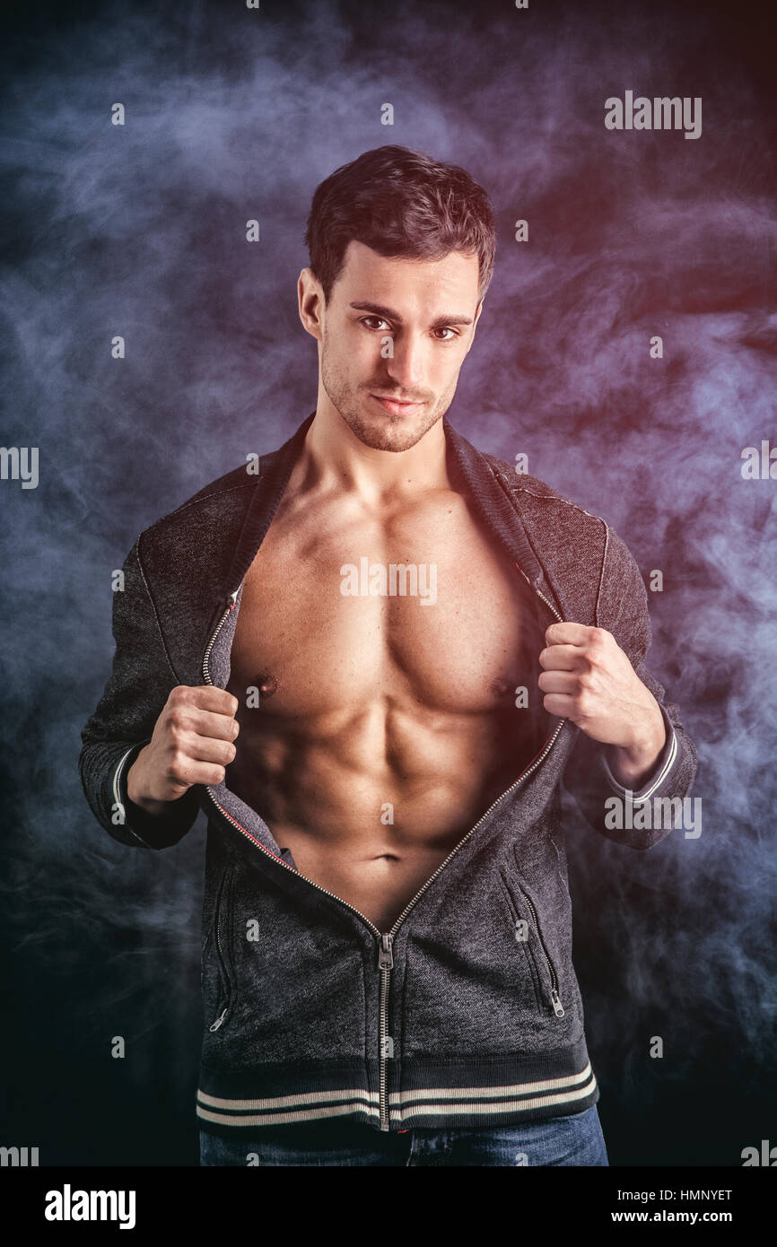 Confident, attractive young man with open vest on Stock Photo - Alamy