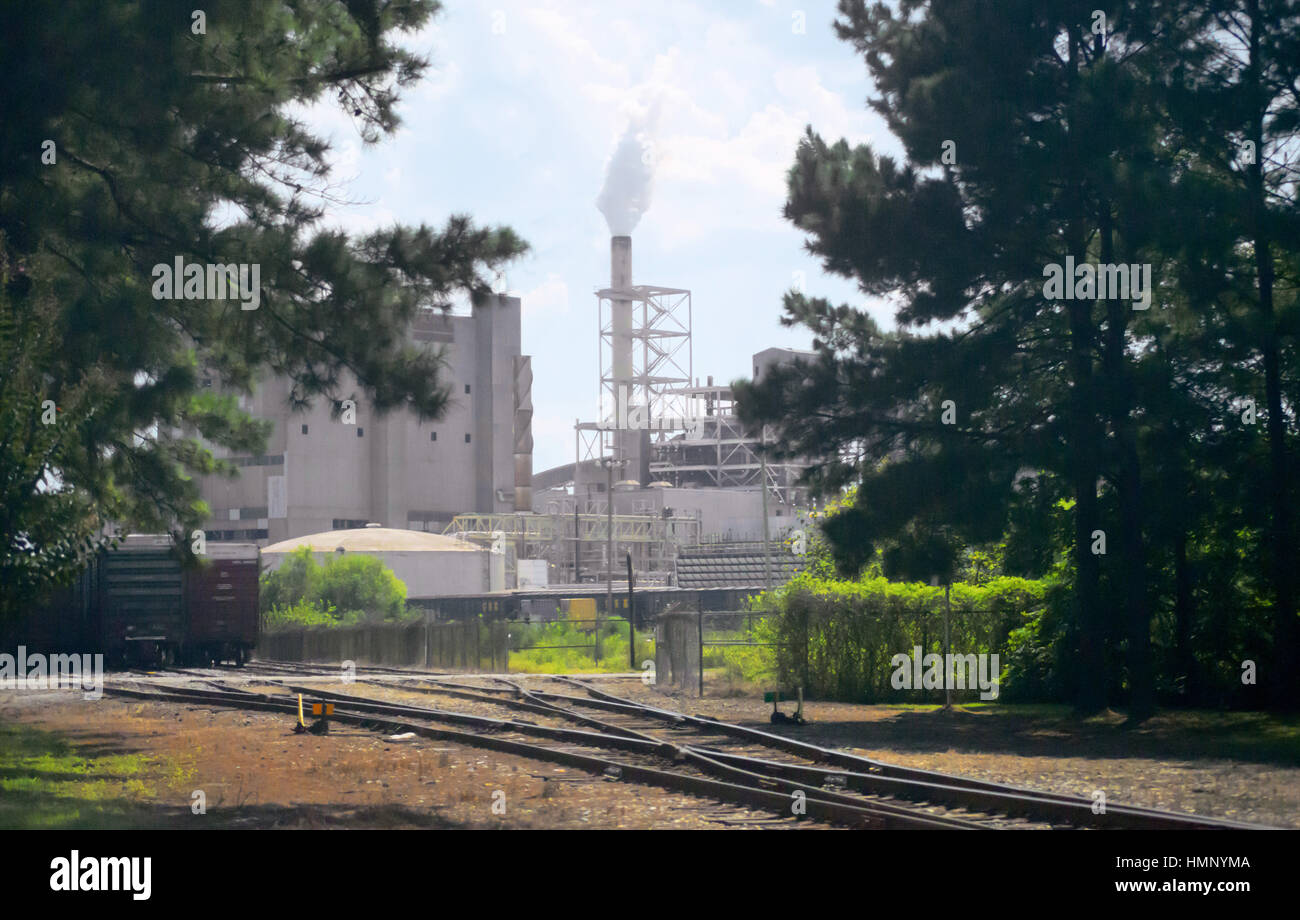 An international paper factory smokestack spewing smoke, looked at ...