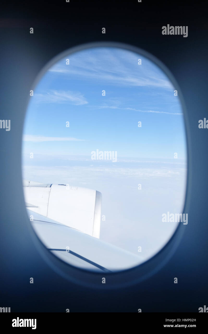 Looking through window aircraft during flight in wing with blue sky ...