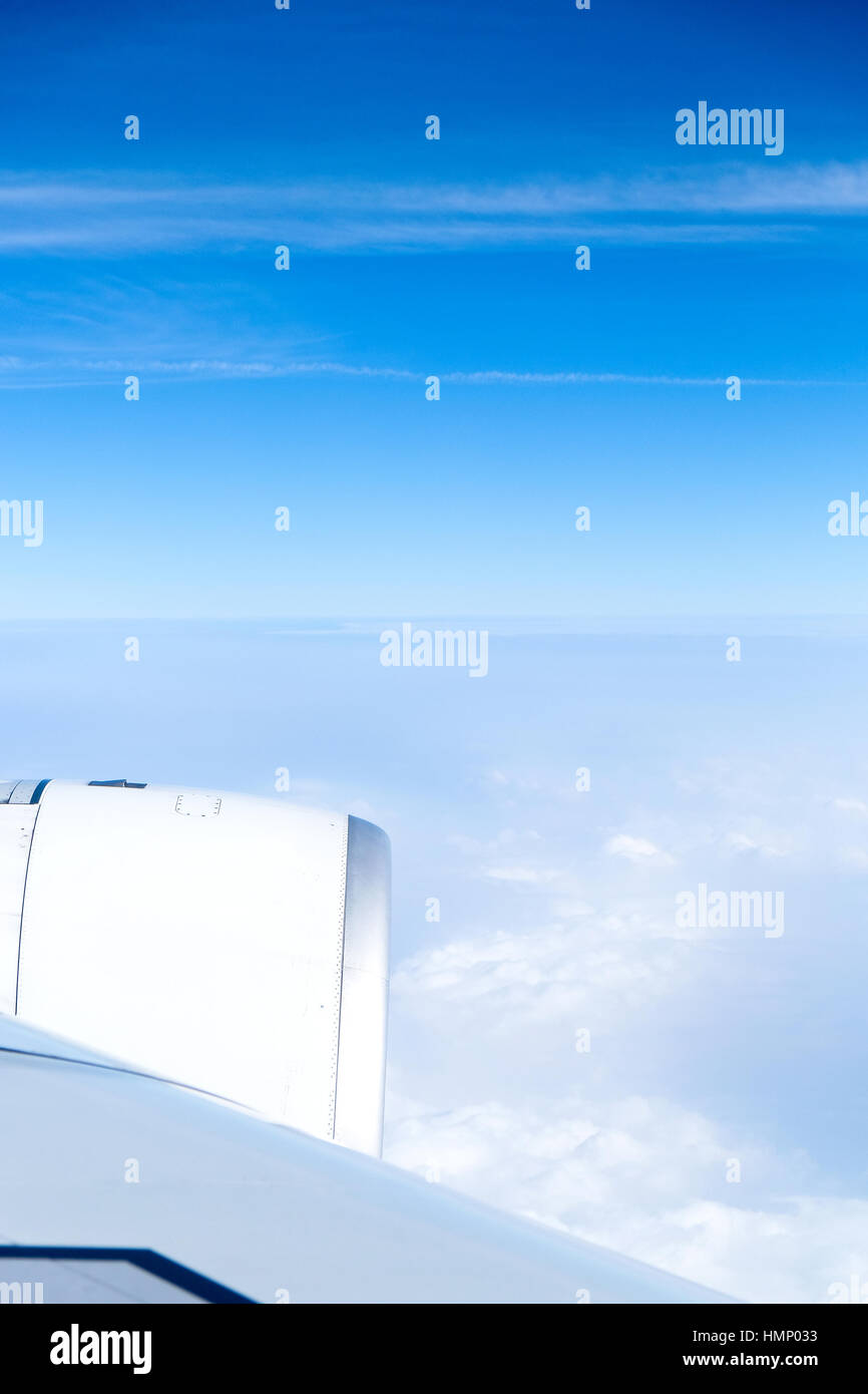 Looking through window aircraft during flight in wing with blue sky ...