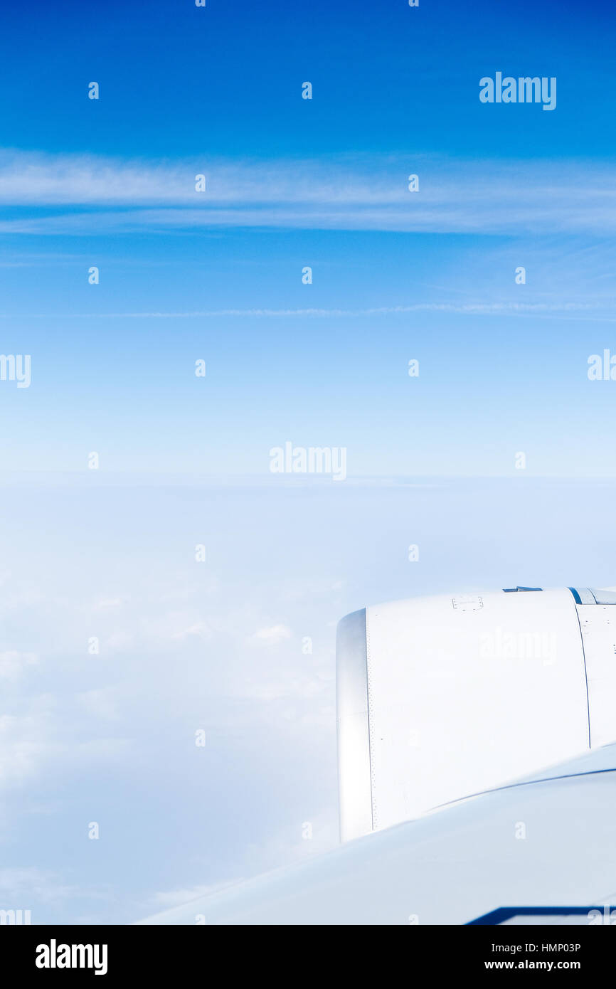 Looking through window aircraft during flight in wing with blue sky ...