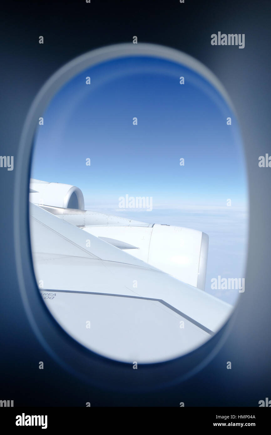 Looking through window aircraft during flight in wing with blue sky ...