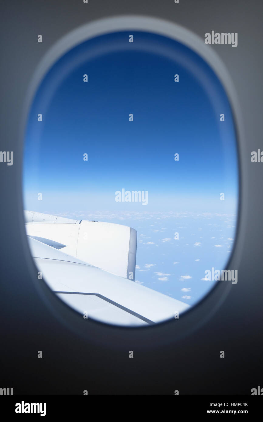 Looking through window aircraft during flight in wing with blue sky ...