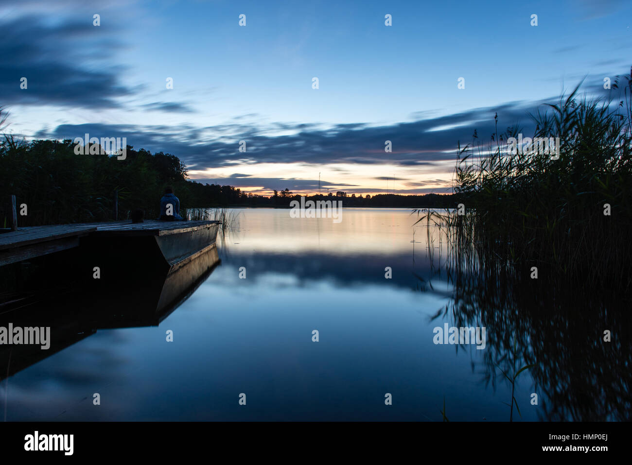 Beautiful cloudscape over the lake, sunset shot with water grass Stock ...
