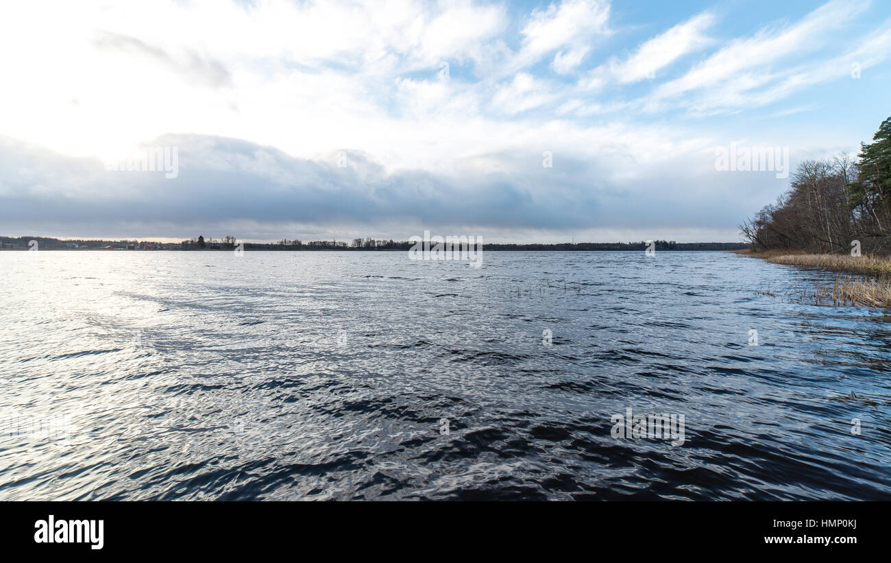 Reflections in the calm lake water with dramatic clouds Stock Photo - Alamy