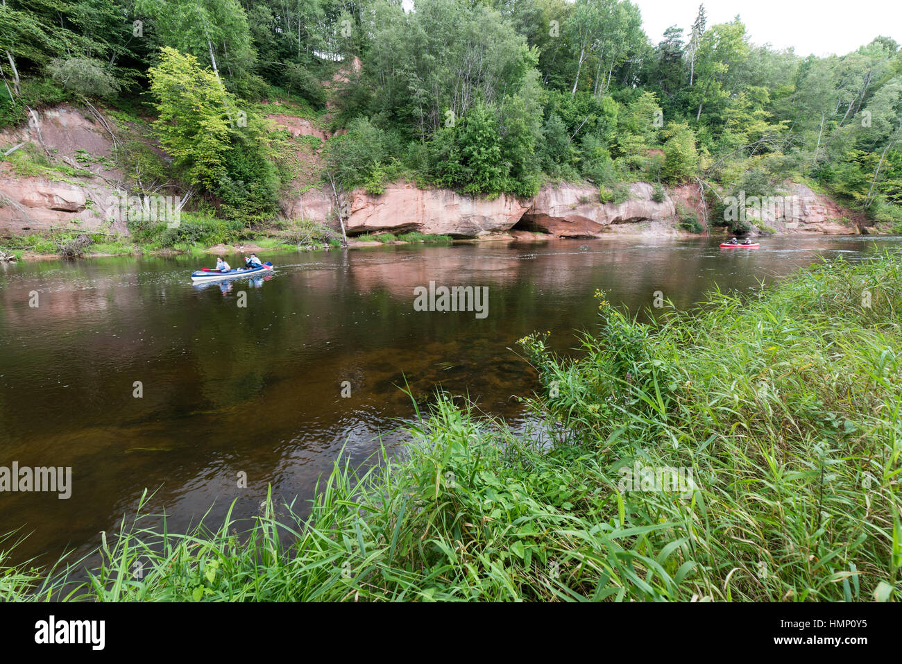 tourists enjoying water sports, kayaking in wild river - Sigulda ...