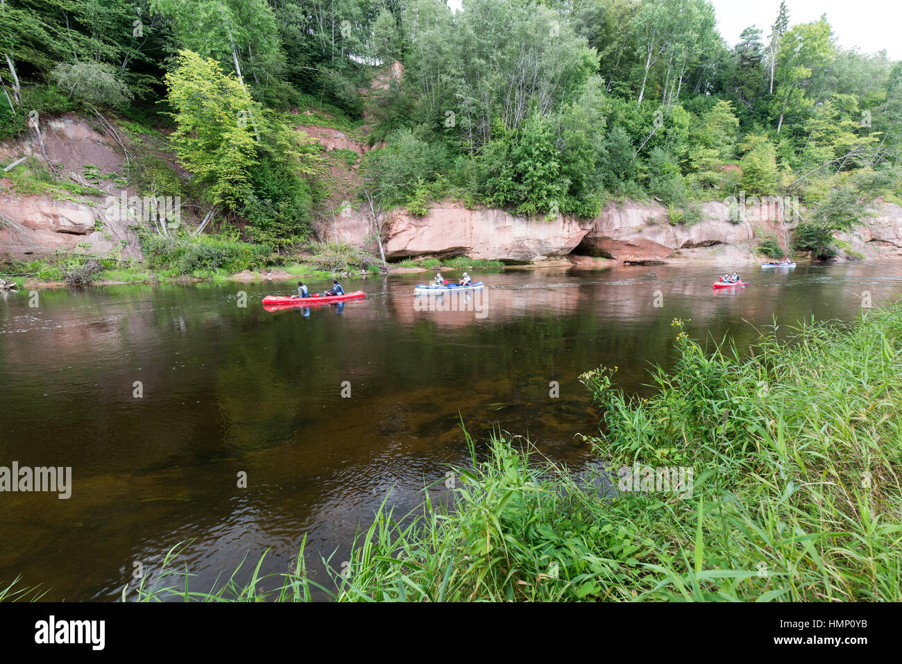 tourists enjoying water sports, kayaking in wild river - Sigulda ...