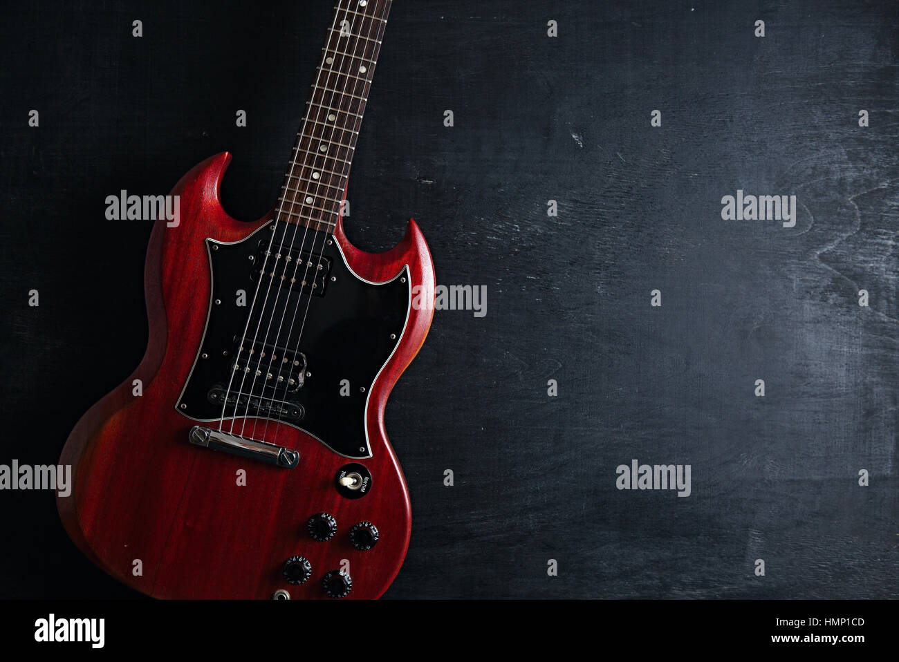 Electric guitar on wooden background Stock Photo - Alamy