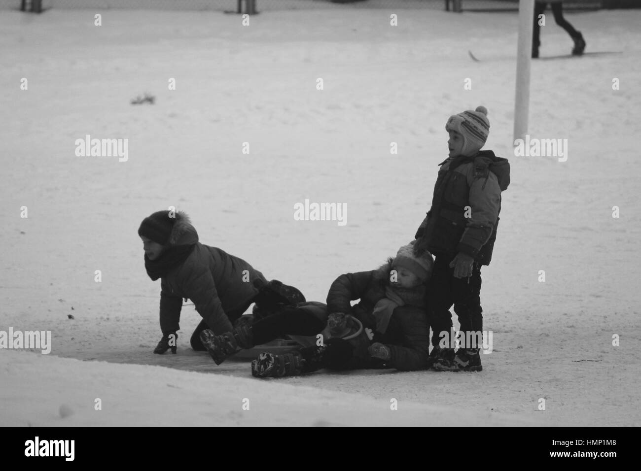 vivid cheerful kidds play on slippery slope with sleds more fun and ...