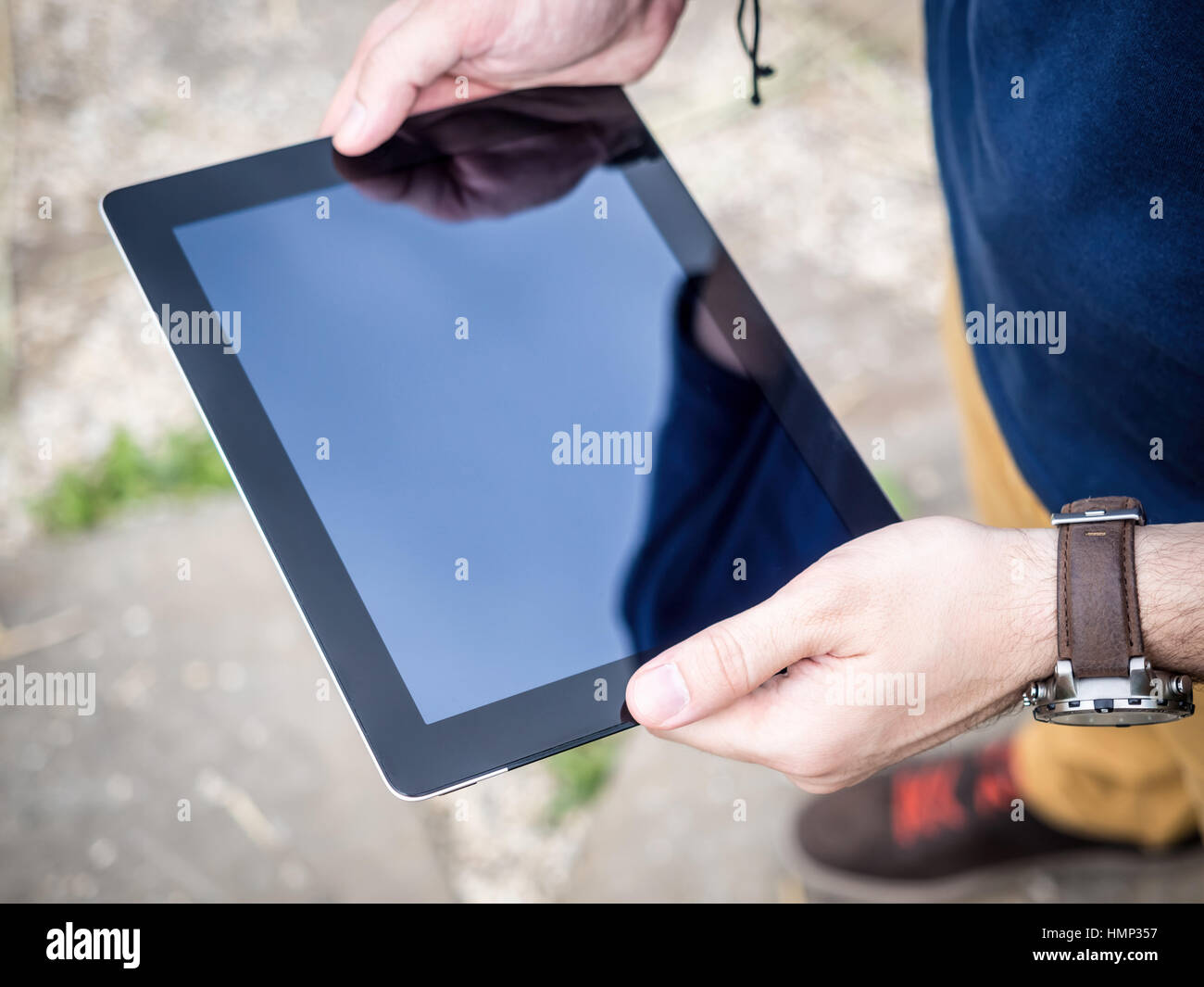 Man using digital Tablet Mockup walking in the park Stock Photo - Alamy
