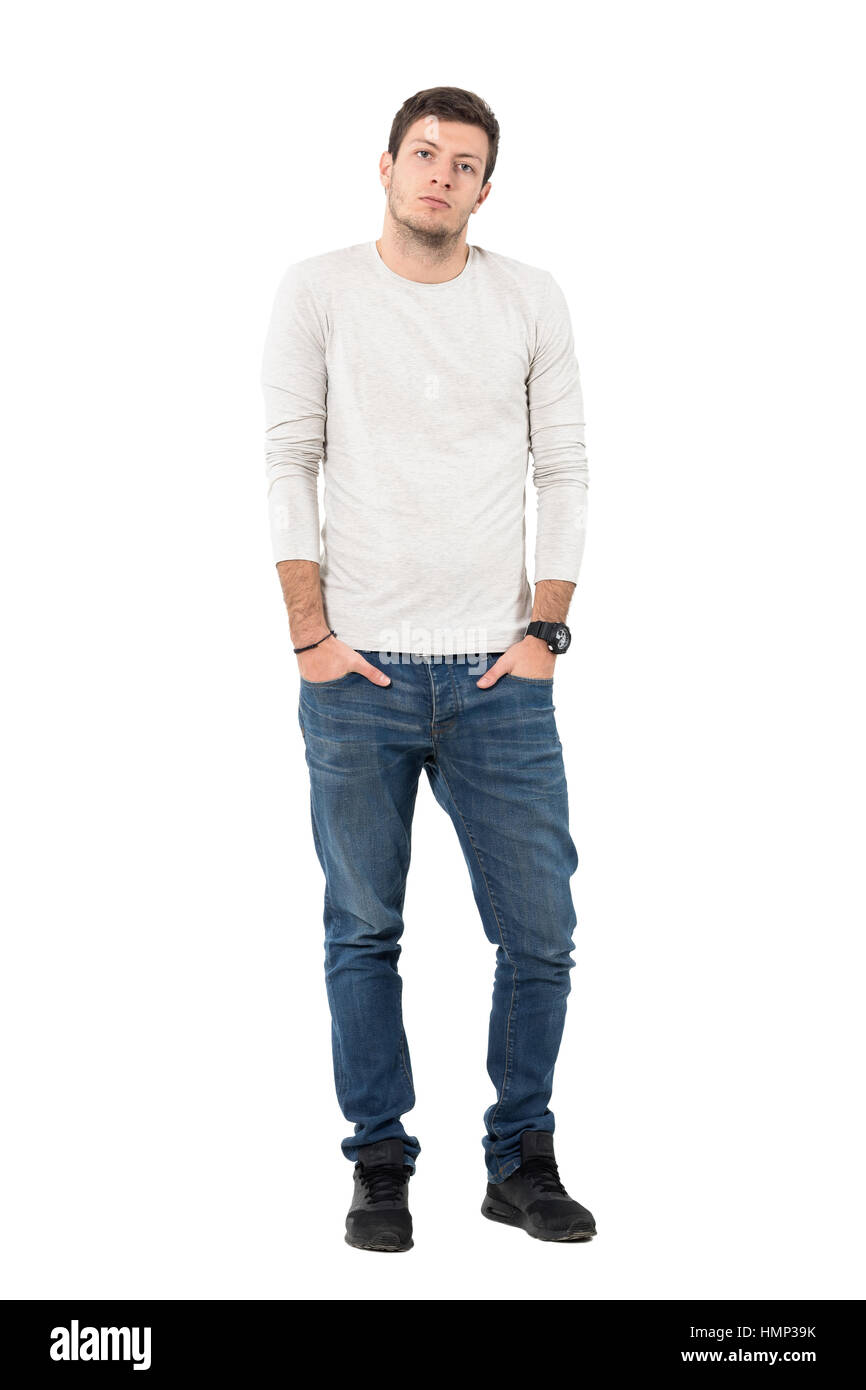 Young casual handsome man wearing jeans and sneakers with hands in ...