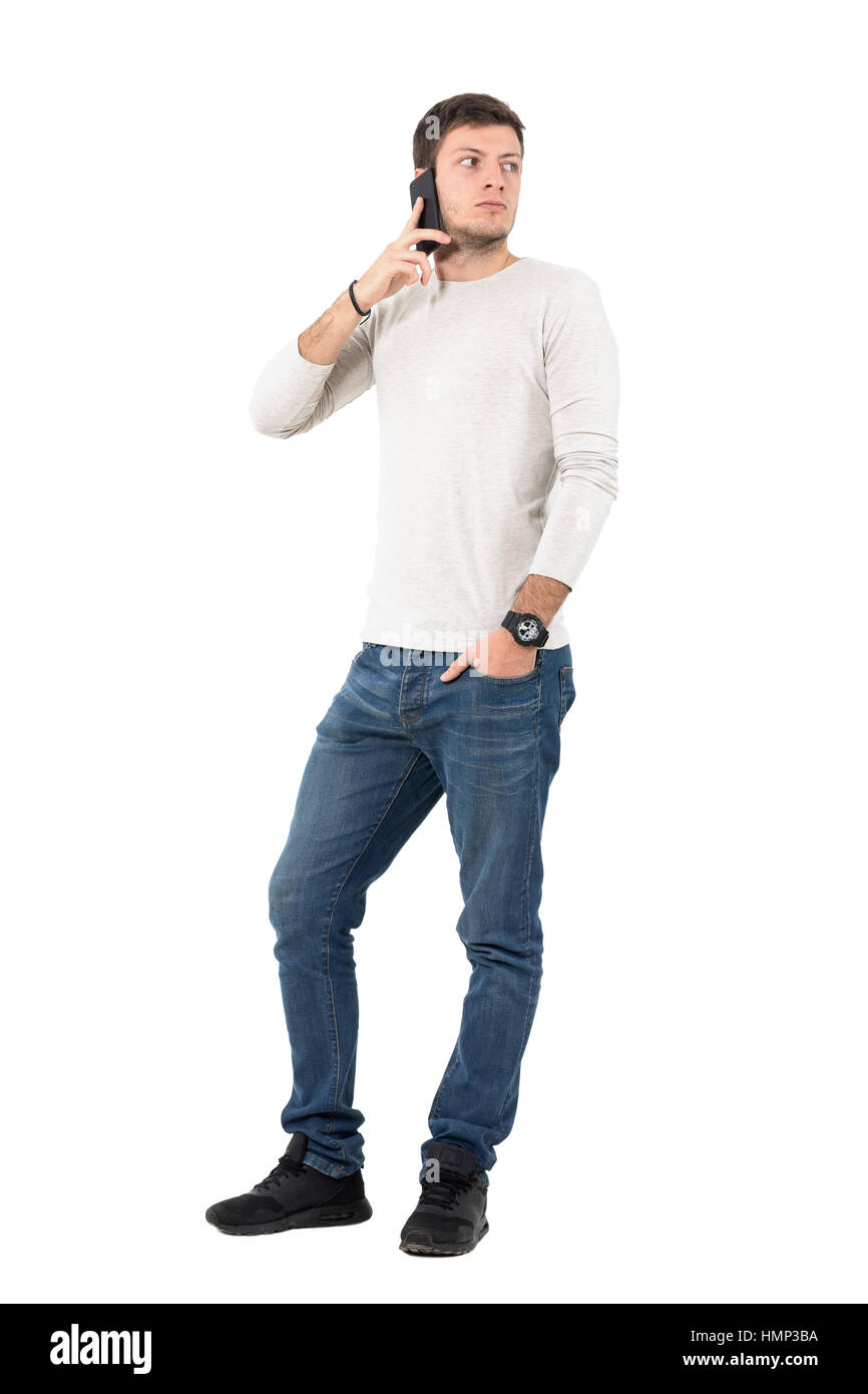 Upset man talking on the phone looking back over the shoulder. Full ...