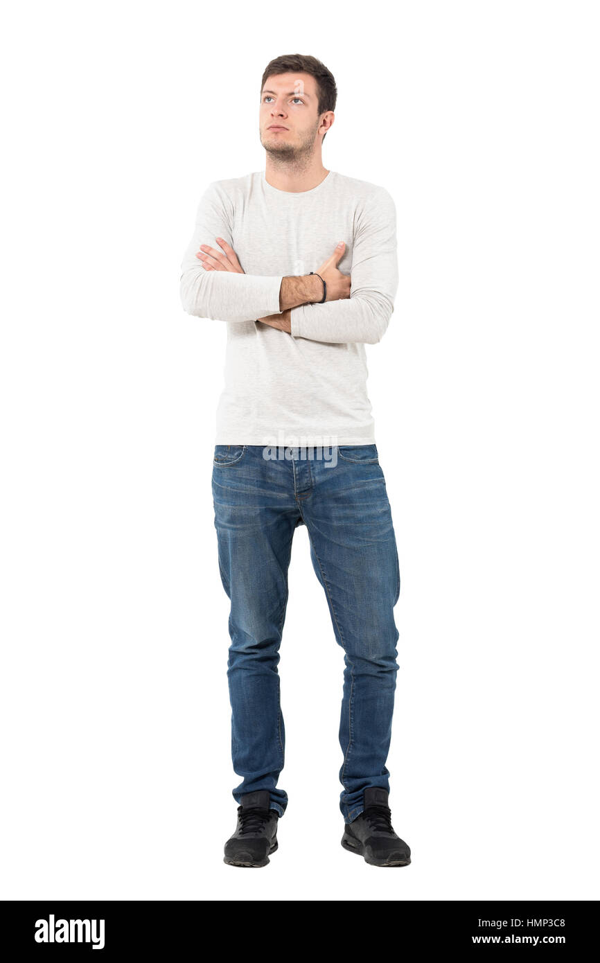 Interested casual man with crossed arms looking up query. Full body ...