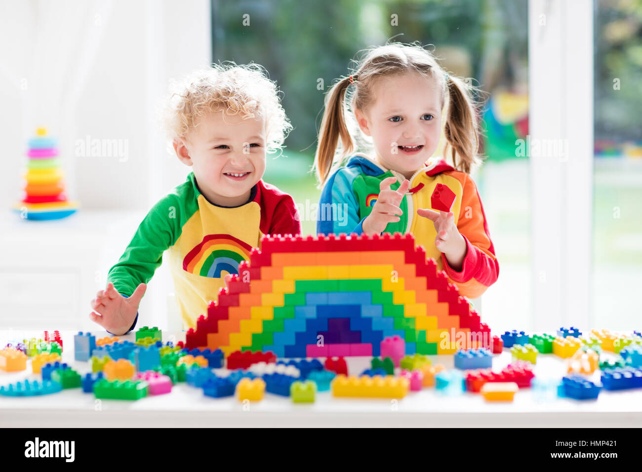 Kids playing with colorful blocks Stock Photo - Alamy
