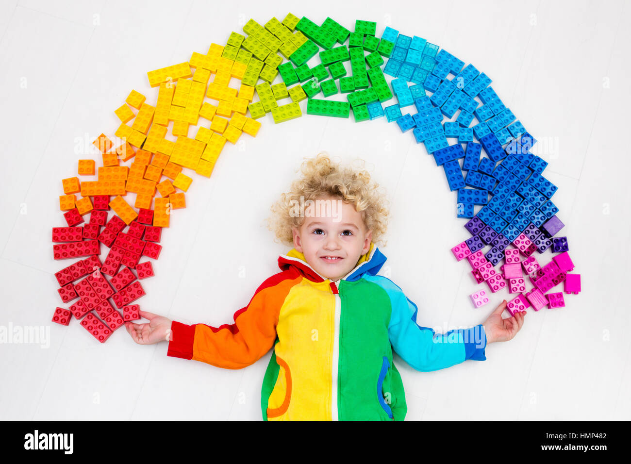Funny little boy playing with colorful rainbow plastic blocks. Kids ...