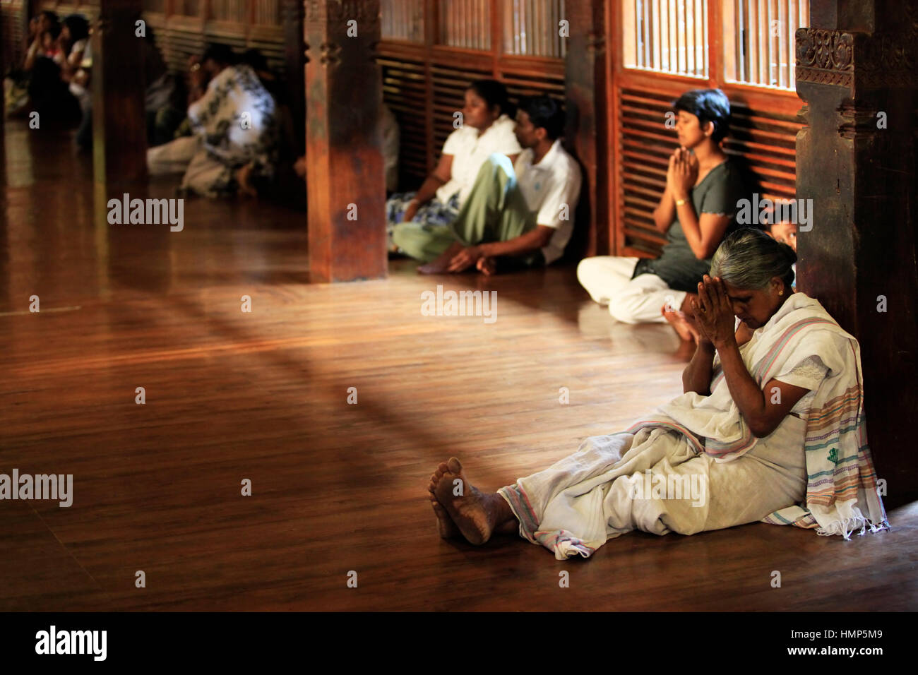 Kandy, Sri Lanka - April 03, 2011: People pray in Buddhist church ...
