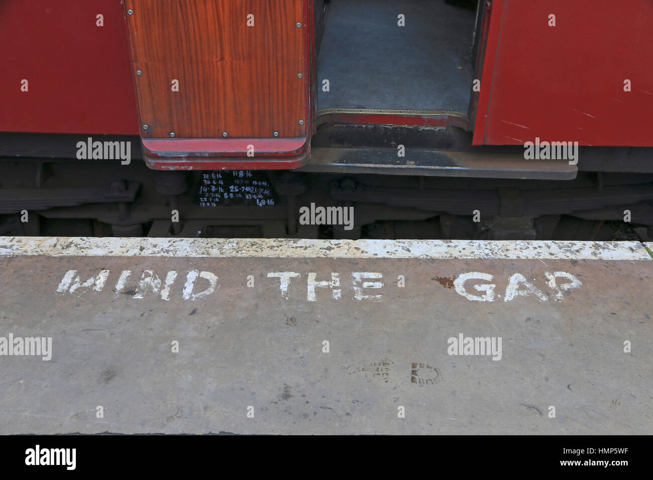 Painted Mind the Gap warning sign Stock Photo - Alamy