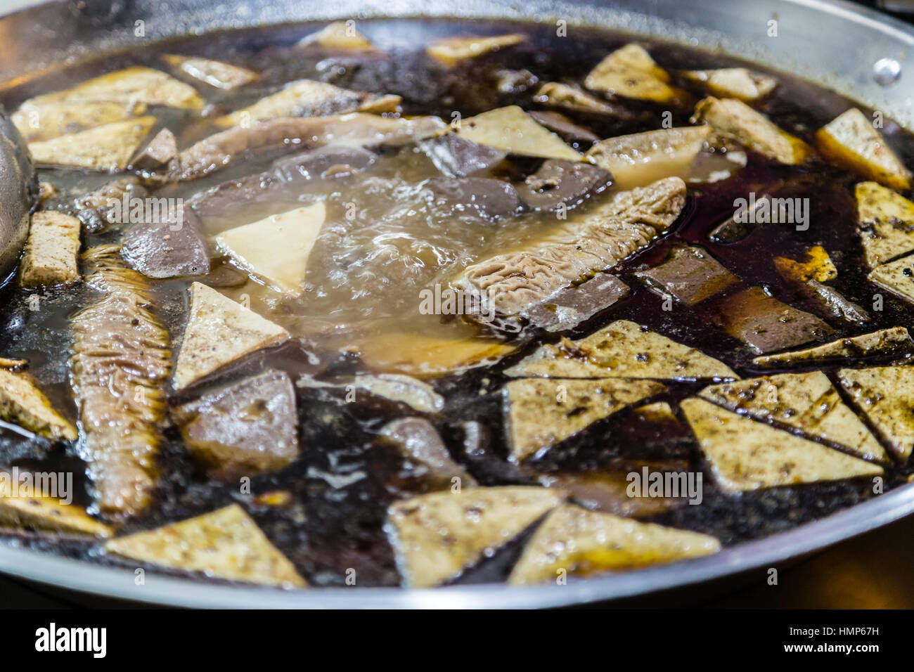 Tofu boiling in steel pot on a vendor's table at night market Stock ...