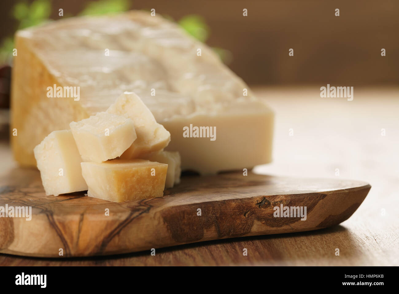 hard parmesan cheese cubes on olive cutting board Stock Photo - Alamy
