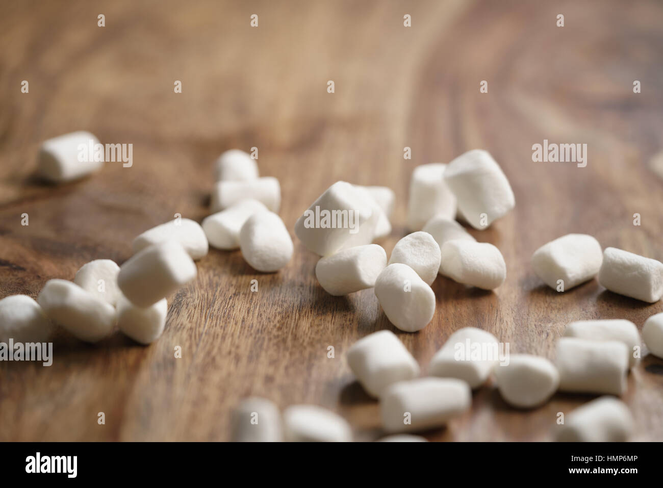 falling white marshmallows on wooden table Stock Photo - Alamy