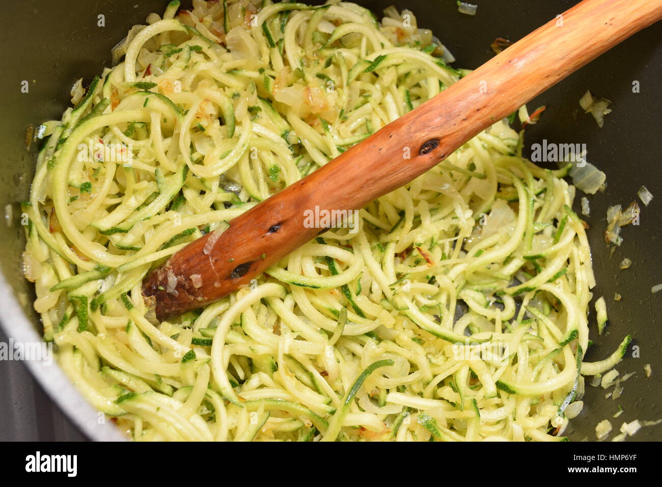 Cooking organic courgette spaghetti Stock Photo - Alamy