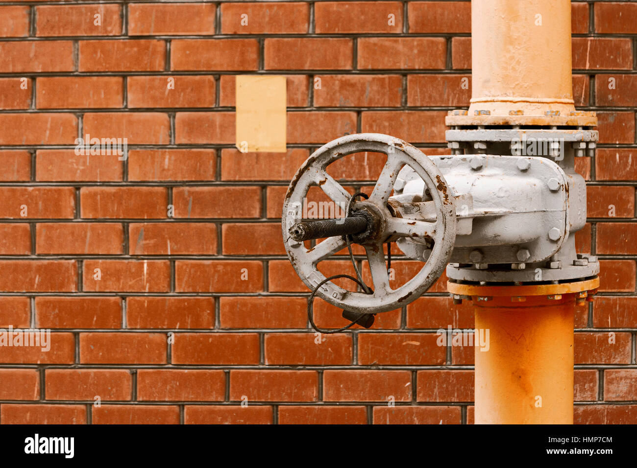 Gas valve on yellow natural gas distribution industrial pipe in front ...