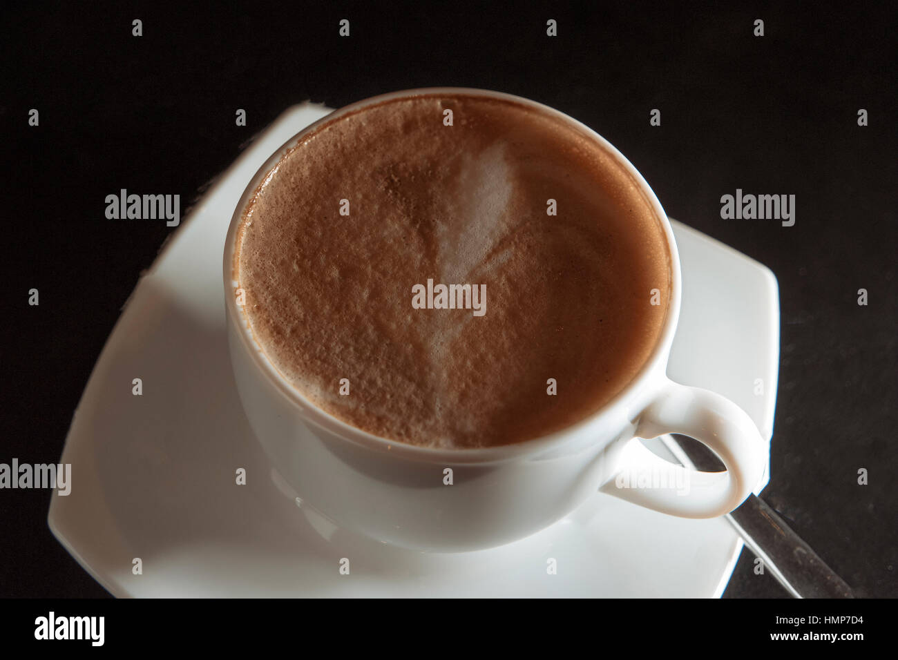 Cappuccino cup overhead view on dark background Stock Photo - Alamy