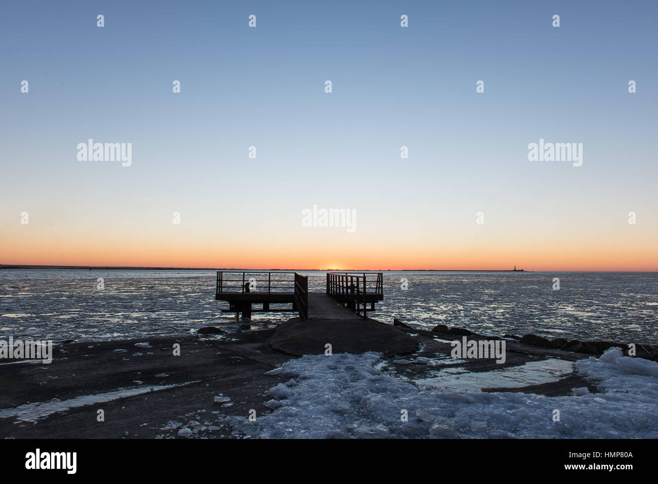 sunset over frozen sea with ice blocks and dramatic colorful sky with ...