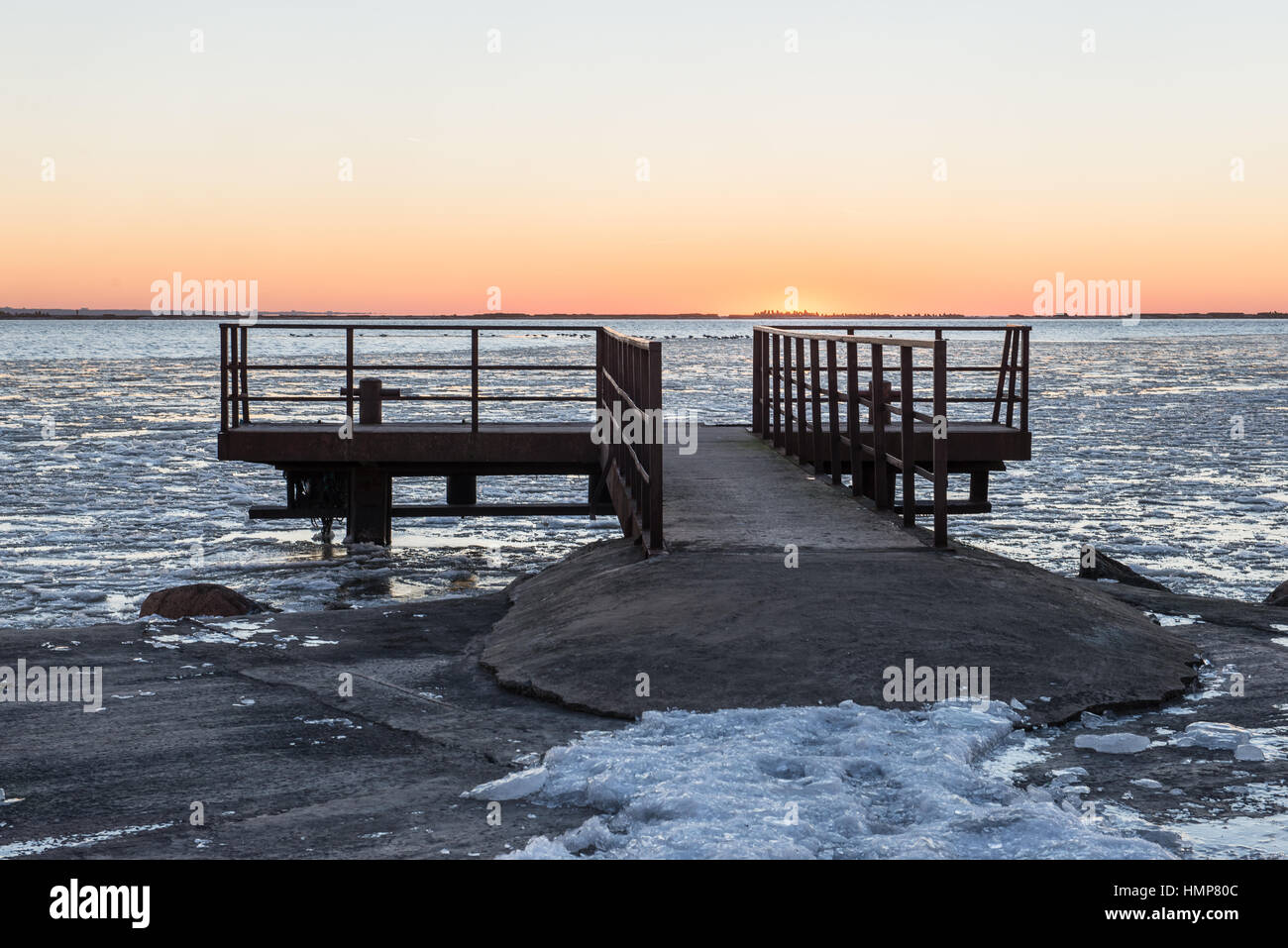 sunset over frozen sea with ice blocks and dramatic colorful sky with ...