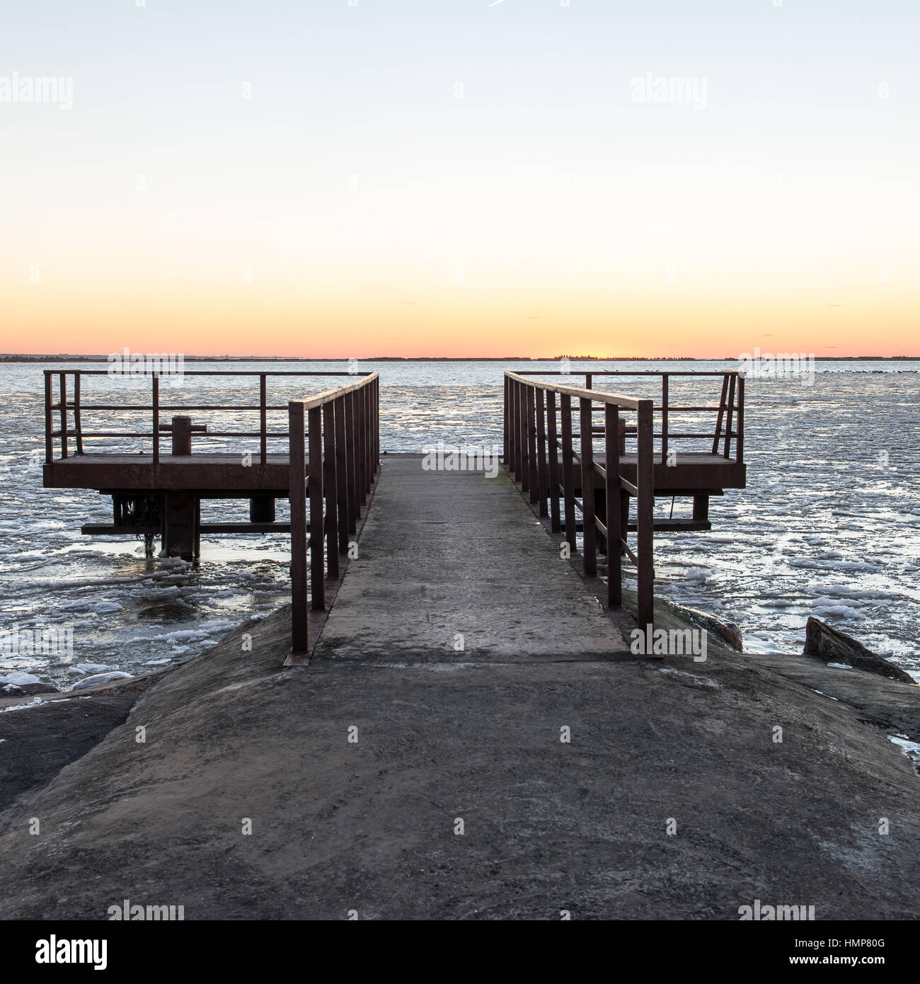 sunset over frozen sea with ice blocks and dramatic colorful sky with ...