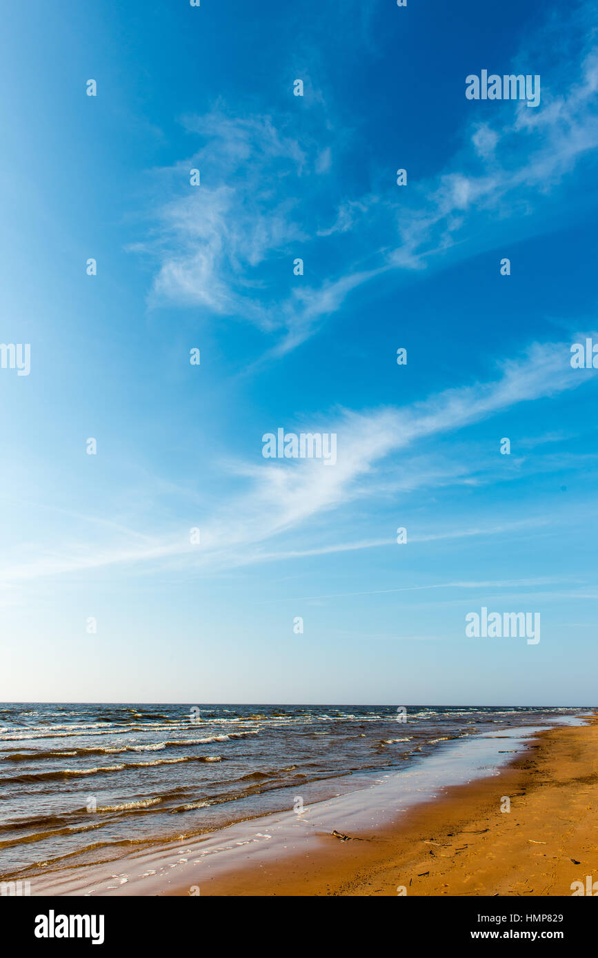 Shoreline of Baltic sea beach with rocks and sand dunes under clouds ...