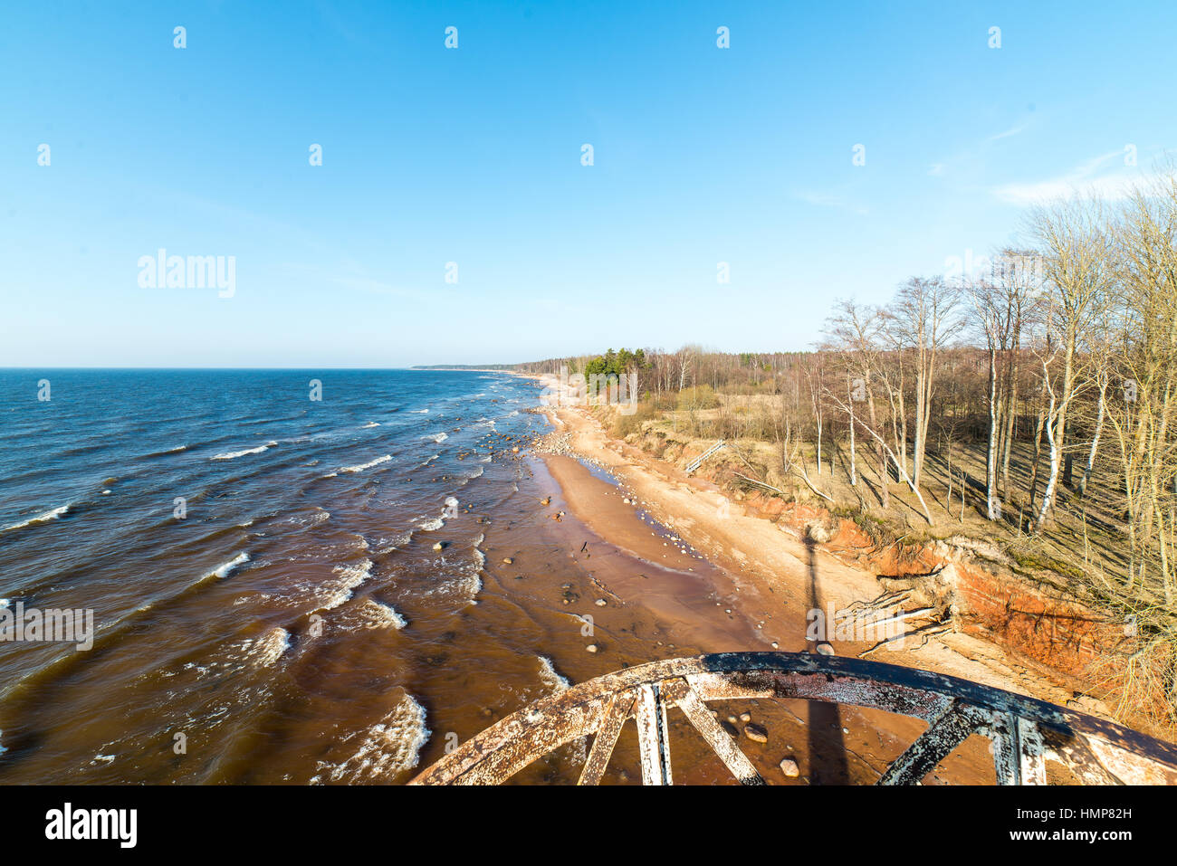 Shoreline of Baltic sea beach with rocks and sand dunes under clouds ...