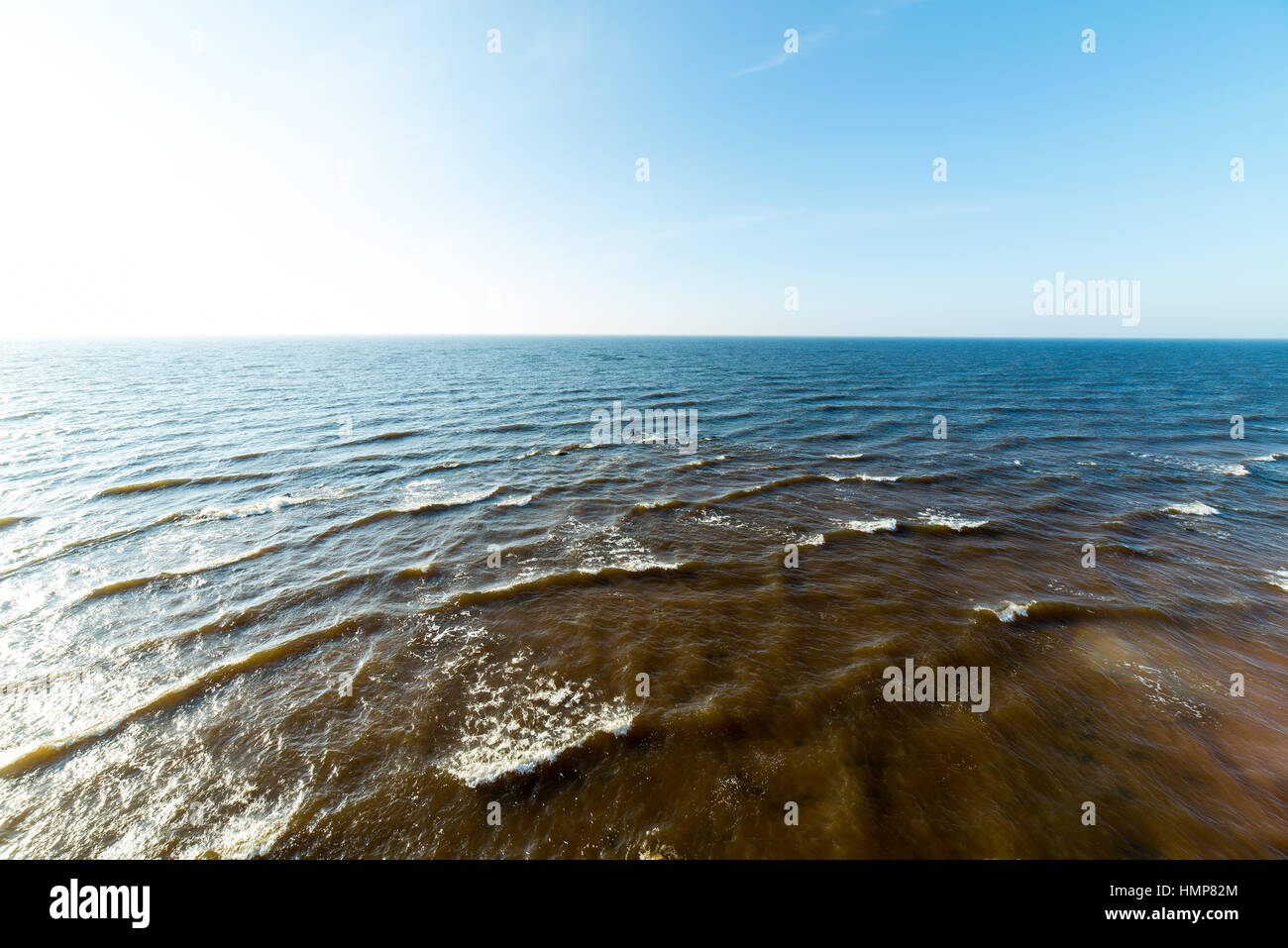 Shoreline of Baltic sea beach with rocks and sand dunes under clouds ...