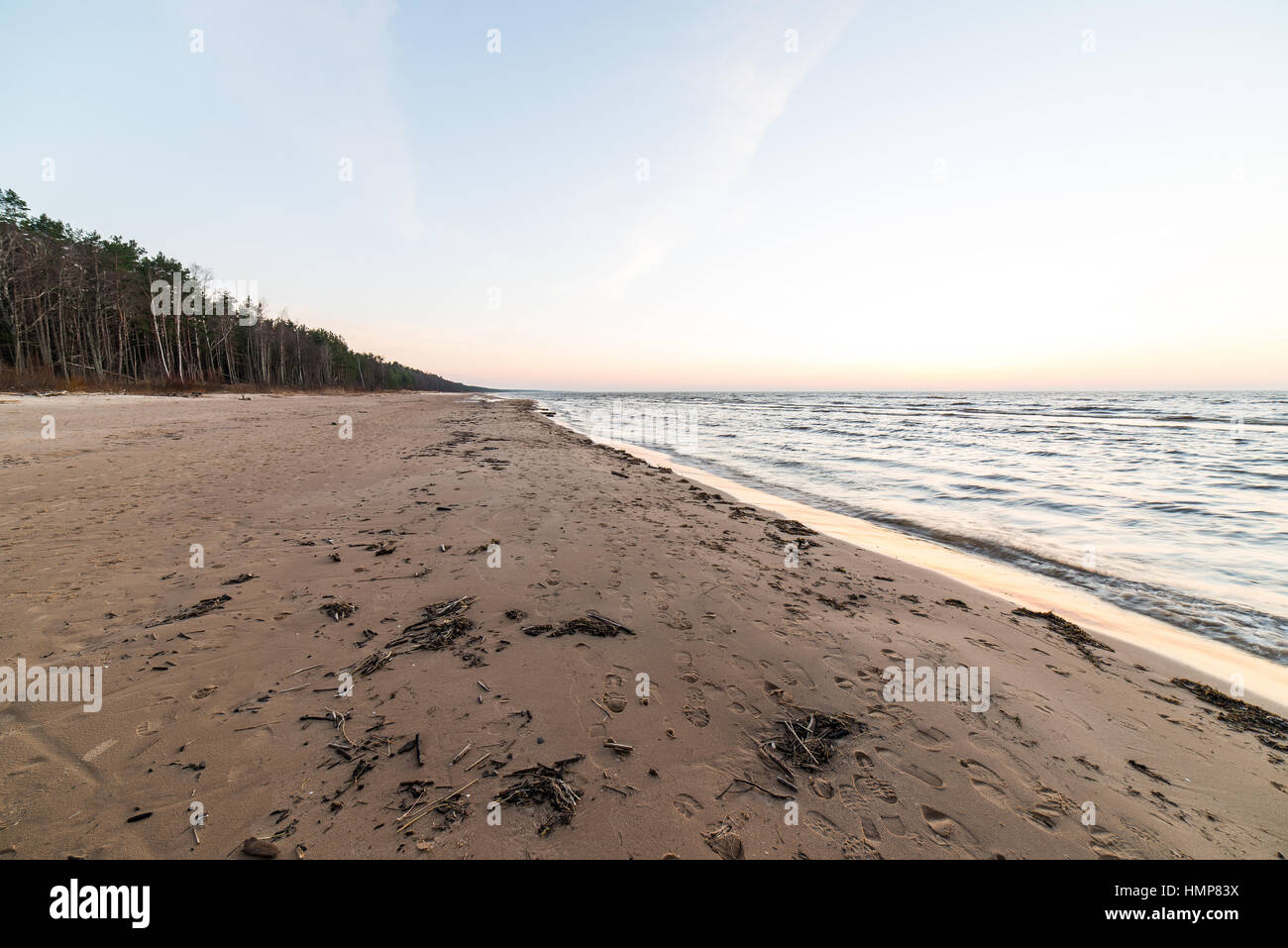 Shoreline of Baltic sea beach with rocks and sand dunes under clouds ...