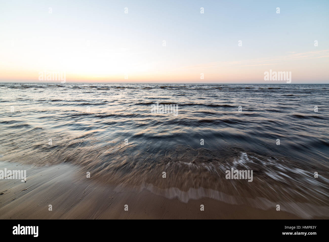 Shoreline of Baltic sea beach with rocks and sand dunes under clouds ...
