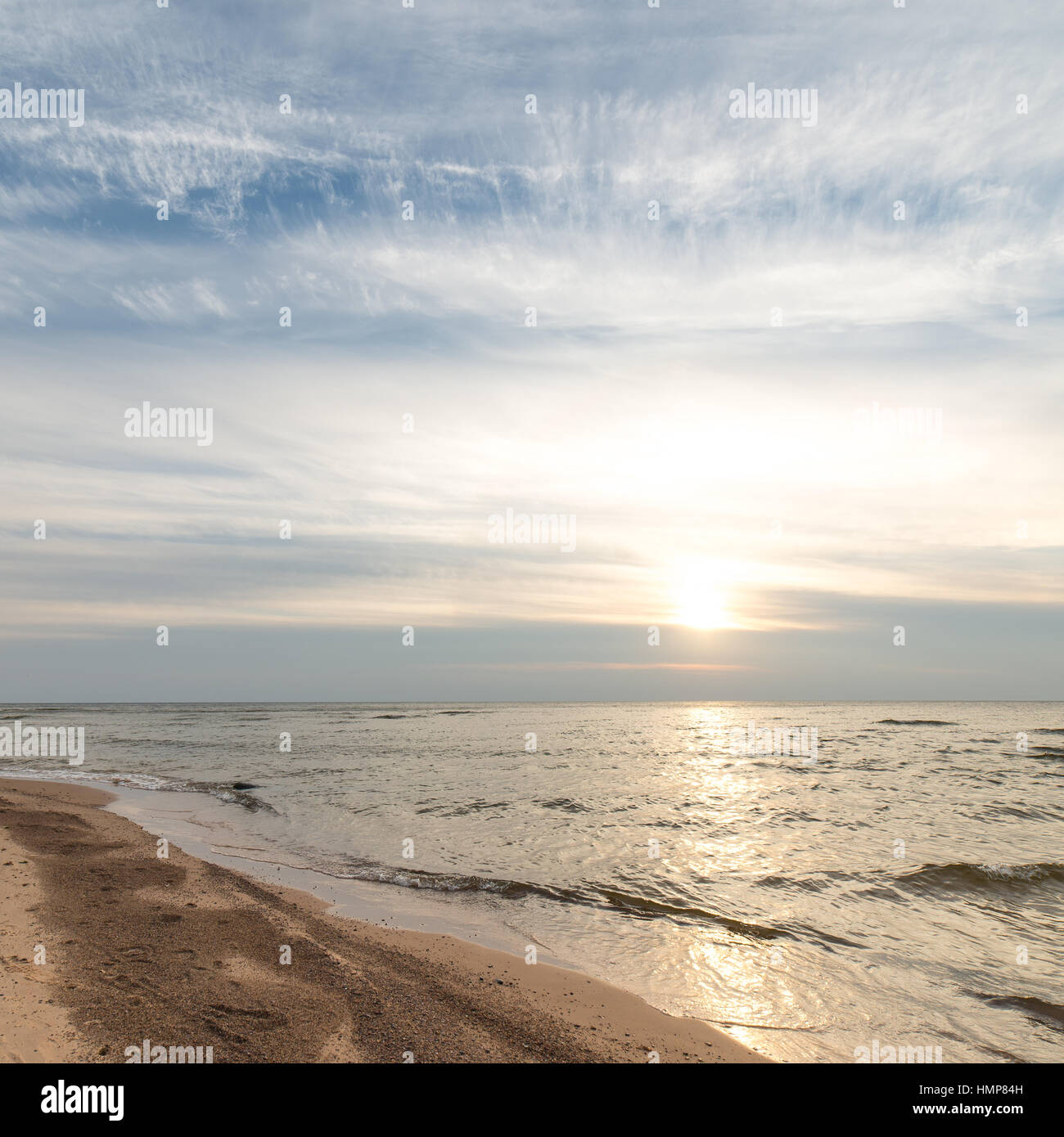 Shoreline of Baltic sea beach with rocks and sand dunes under clouds ...