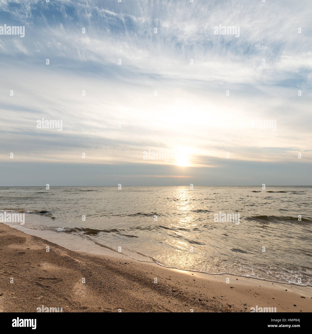 Shoreline of Baltic sea beach with rocks and sand dunes under clouds ...