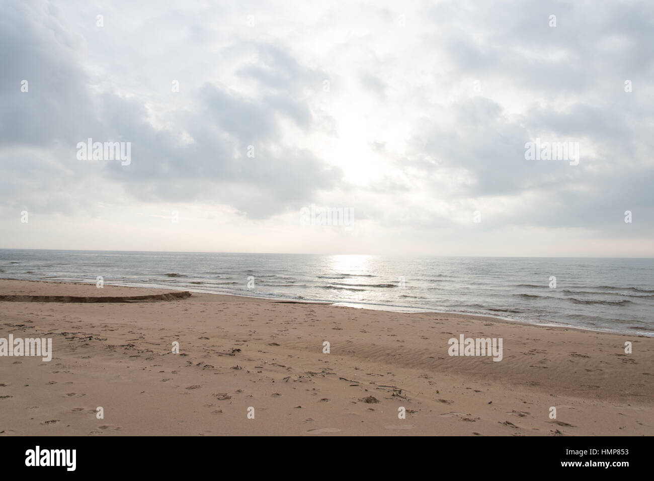 Shoreline of Baltic sea beach with rocks and sand dunes under clouds ...