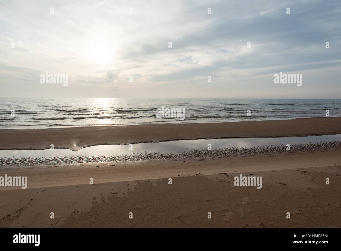 Shoreline of Baltic sea beach with rocks and sand dunes under clouds ...