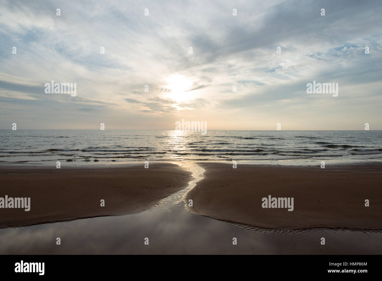 Shoreline of Baltic sea beach with rocks and sand dunes under clouds ...
