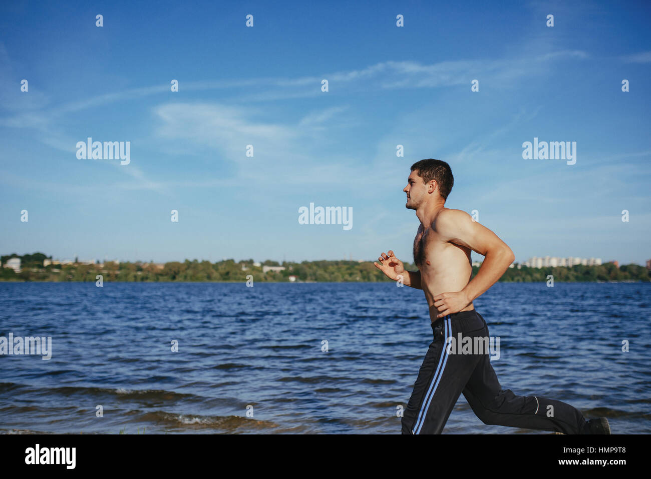young attractive guy trains in the morning Stock Photo - Alamy