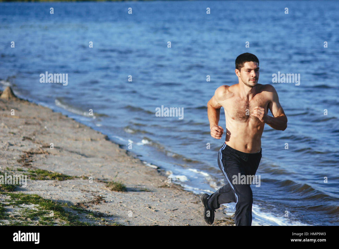 young attractive guy trains in the morning Stock Photo - Alamy